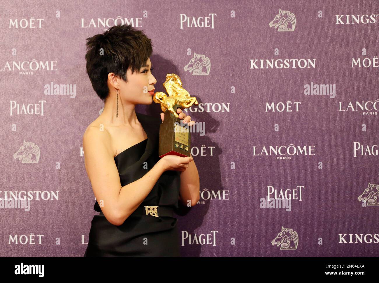 Singapore's actress Yeo Yann Yann holding a trophy, poses for media for Best Supporting Actress ...