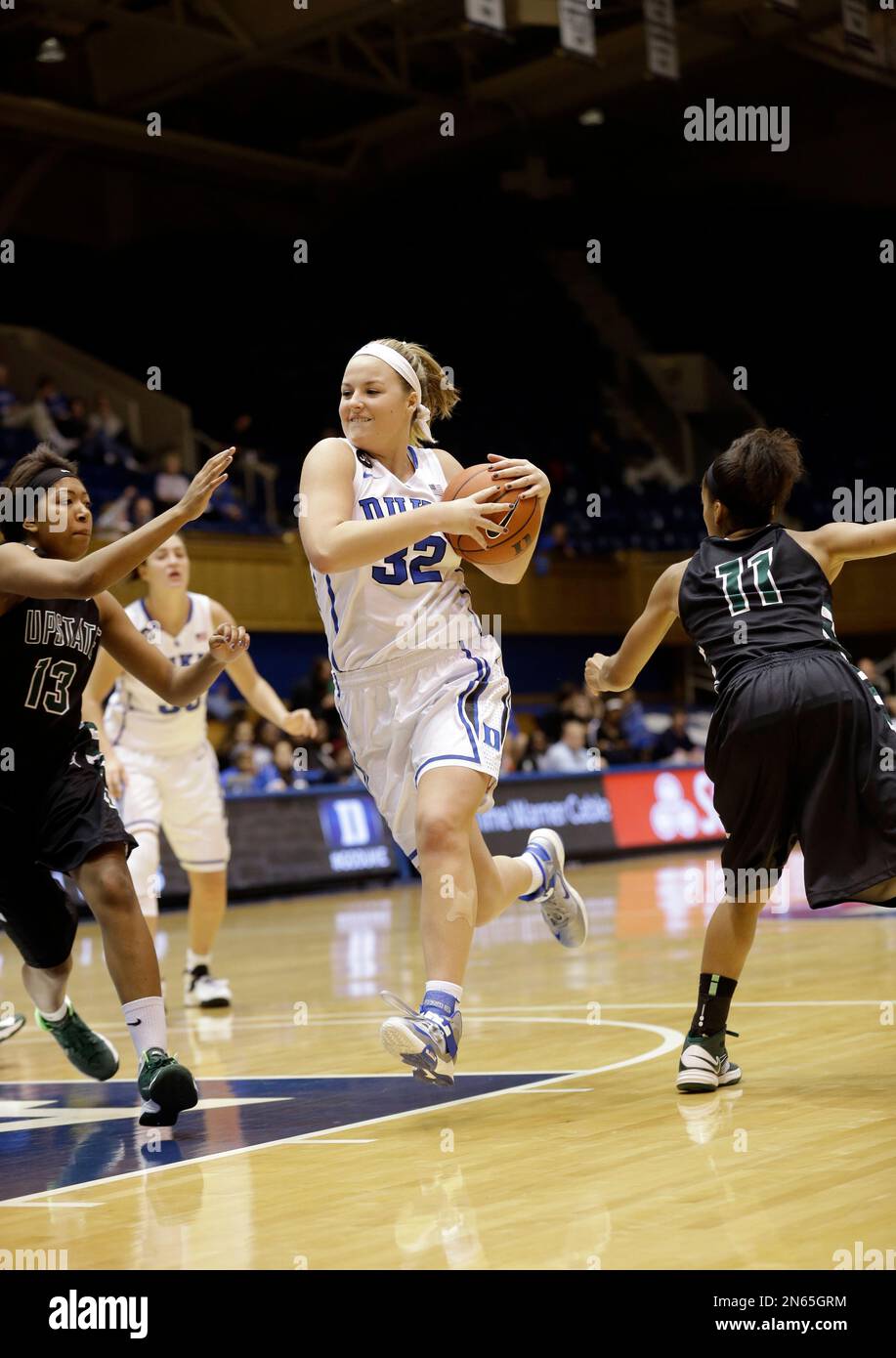 Duke's Tricia Liston (32) drives between USC Upstate's Raven Jefferson ...