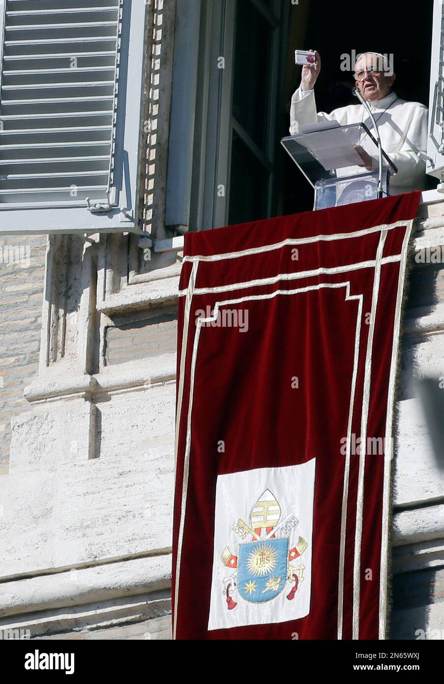 Pope Francis shows a box shaped like a pill box but which contains a ...