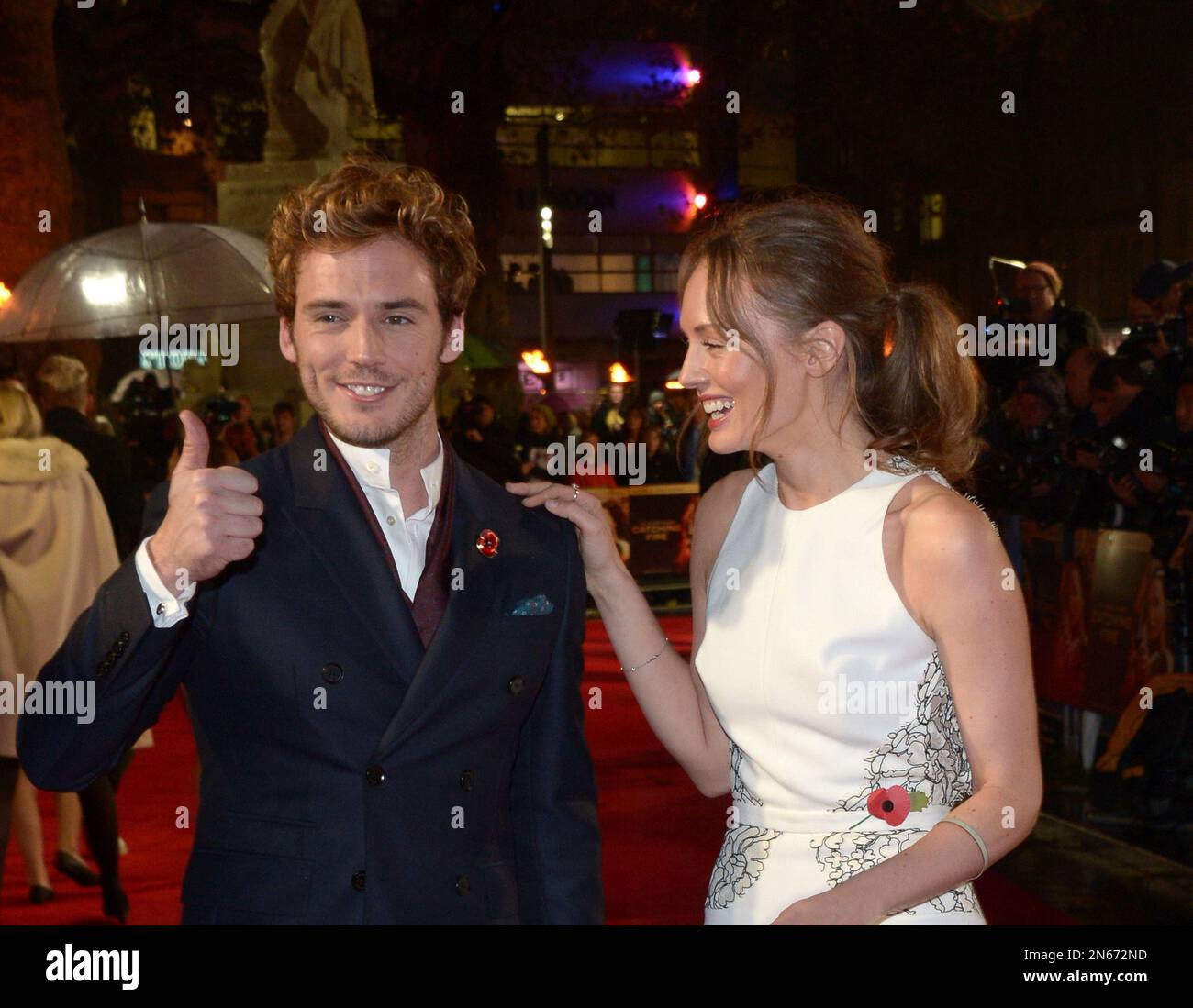Actor Sam Claflin and Laura Haddock pose for photographers as they ...