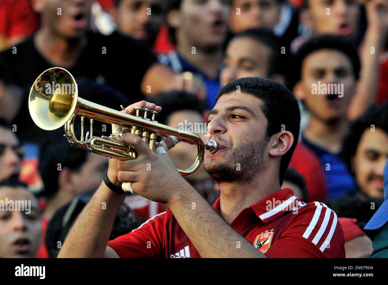 An Egyptian club Al Ahly fan plays the trumpet during the African ...