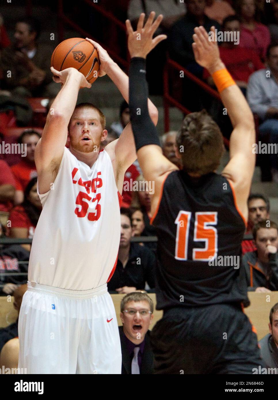 New Mexico's Alex Kirk shoots over Jamestown's Matt Wingo in the first ...