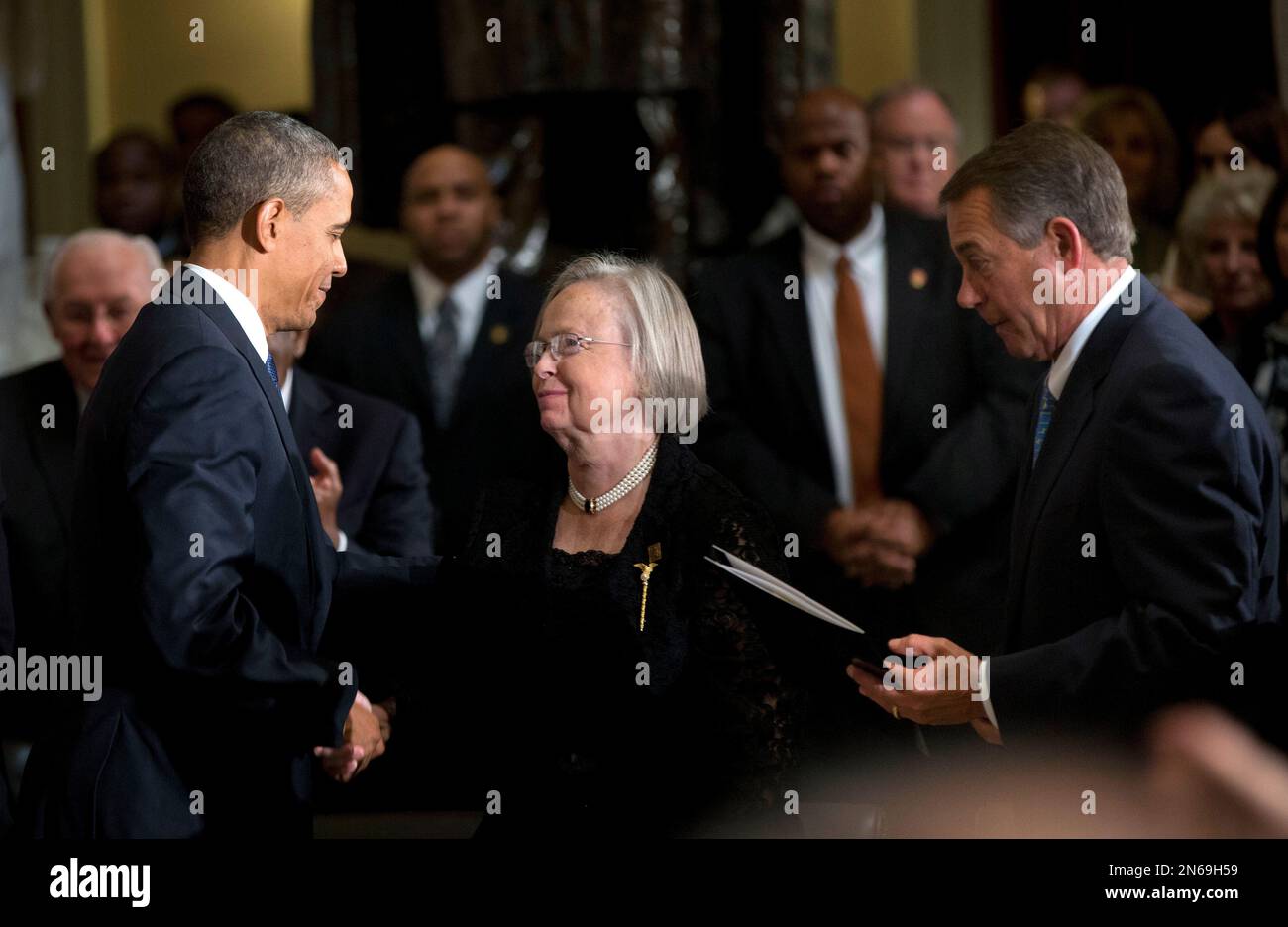 President Barack Obama, left, greets Heather Foley, center, widow of ...