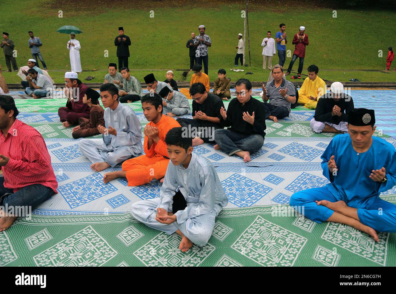 Singaporean Muslims pray outside the Darul Makmur Mosque during Eid al ...