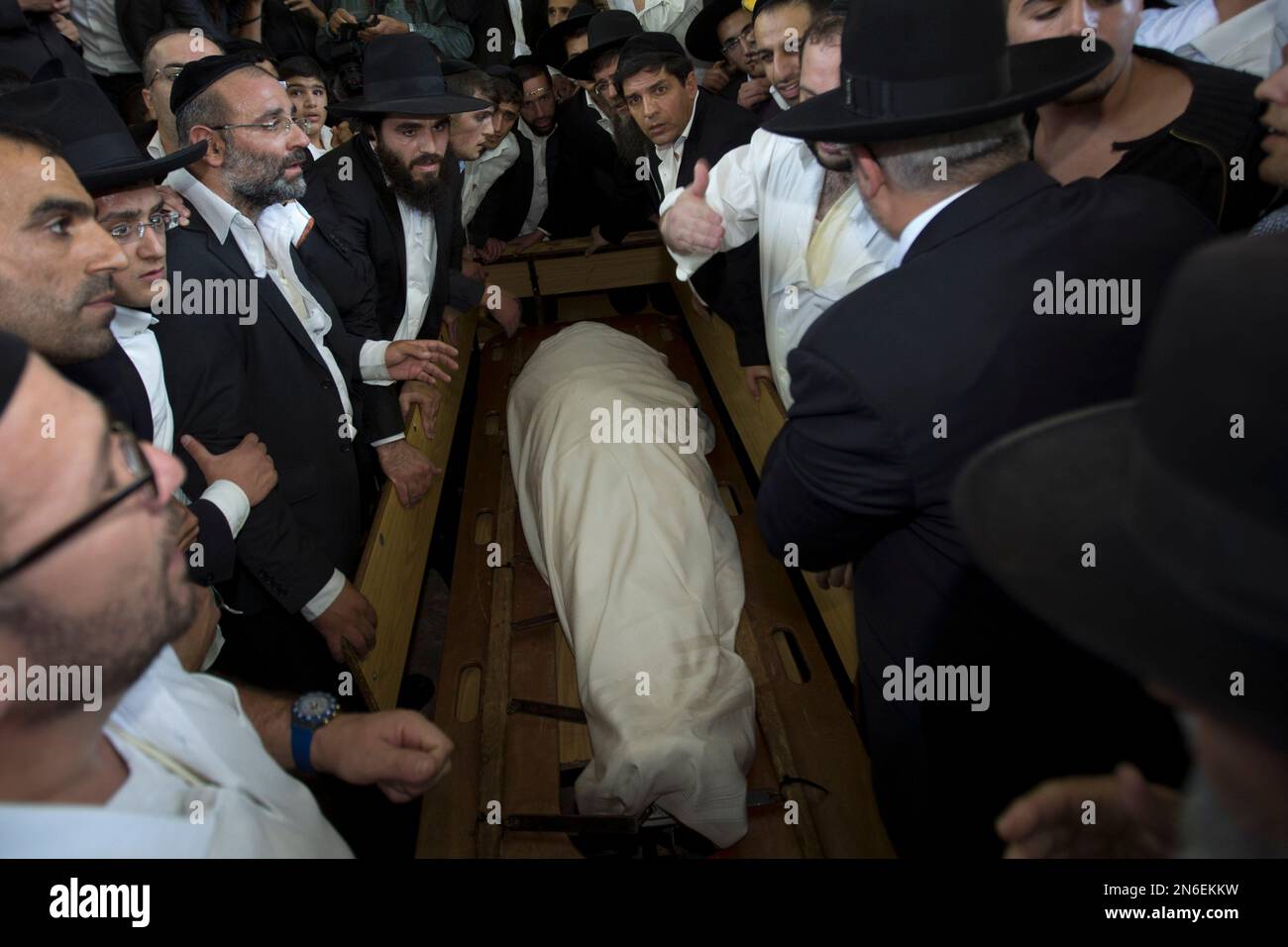 Ultra-Orthodox Jews gather around the body of Rabbi Ovadia Yosef during ...