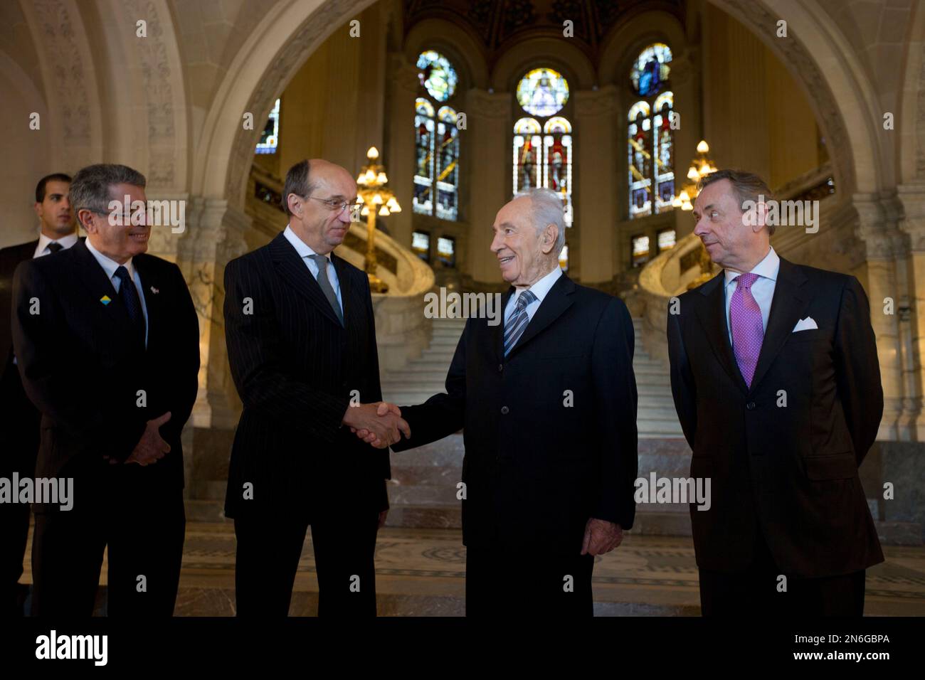 Israel's President Shimon Peres, center right, is greeted by ...