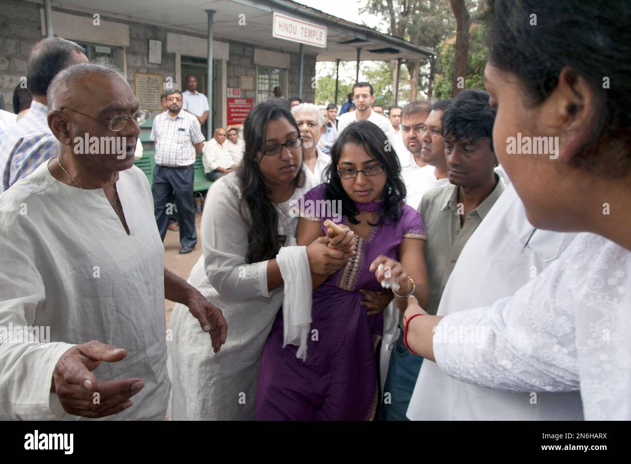 Family members console Rupal Shah, center, the wife of Mitul Amritlal Shah, of Bidco Group of ...