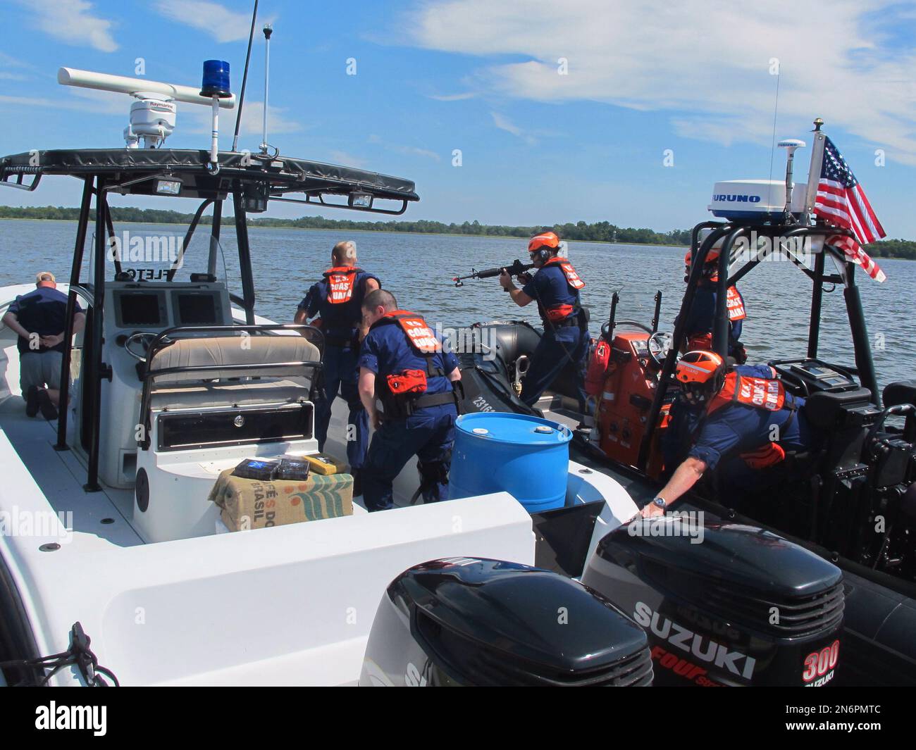 Coast Guard personnel demonstrate a training exercise on boarding a ...