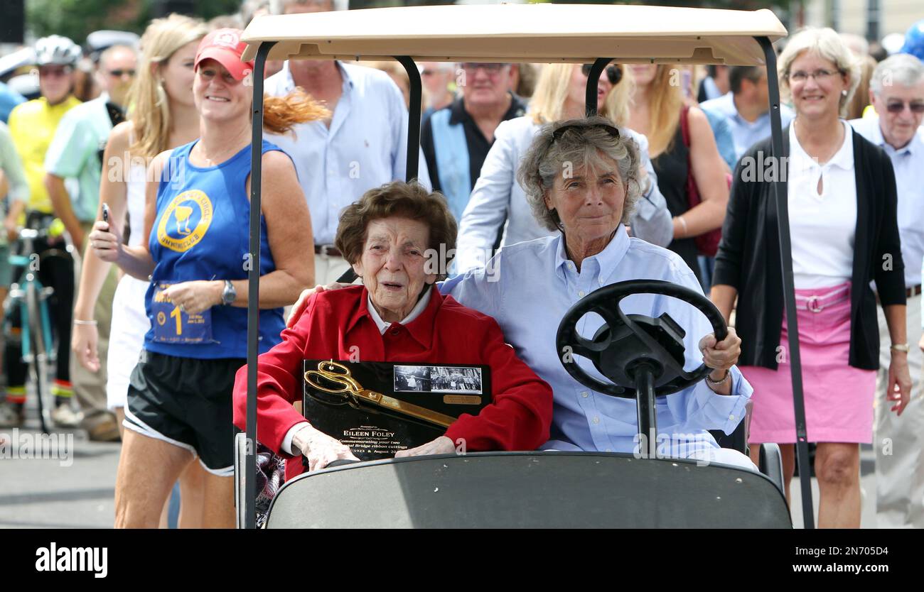 Former Portsmouth mayor Eileen Foley, left in cart, gets a ride across ...