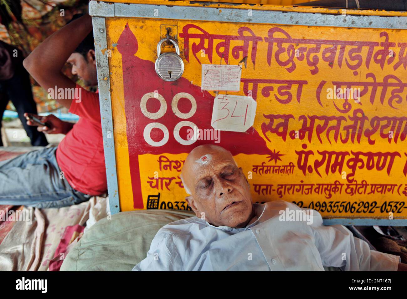 An Indian Panda, or Brahmin Hindu priest, rests at Sangam, the ...