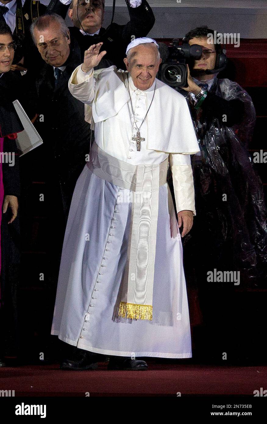 Pope Francis waves to pilgrims as he arrives to the stage during a ...