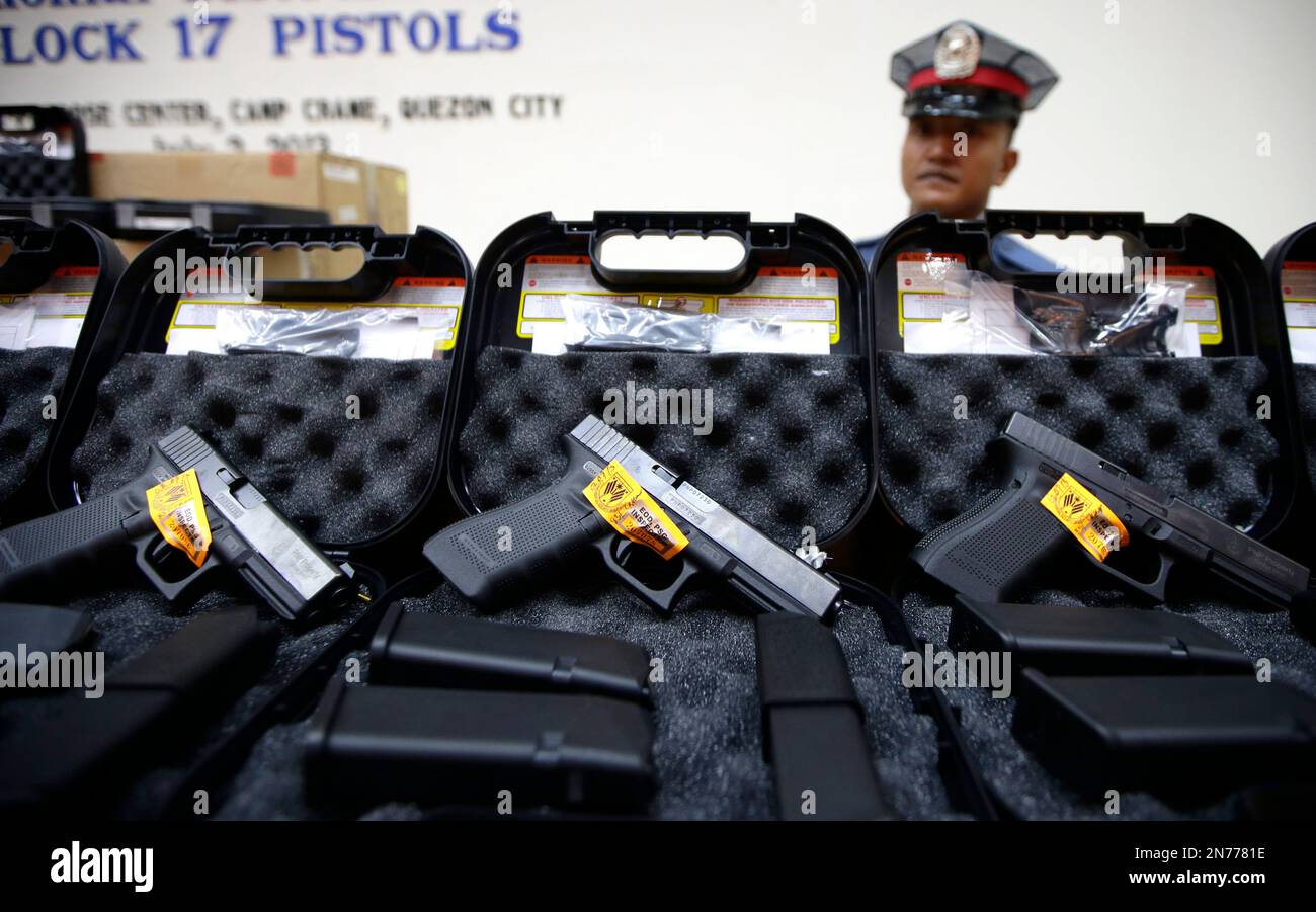 A Philippine police officer guards brand new Glock 17 pistols to be ...