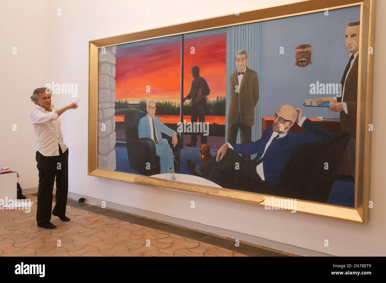 French philosopher and writer Bernard Henri Levy poses in front painting "La Datcha" by artists ...