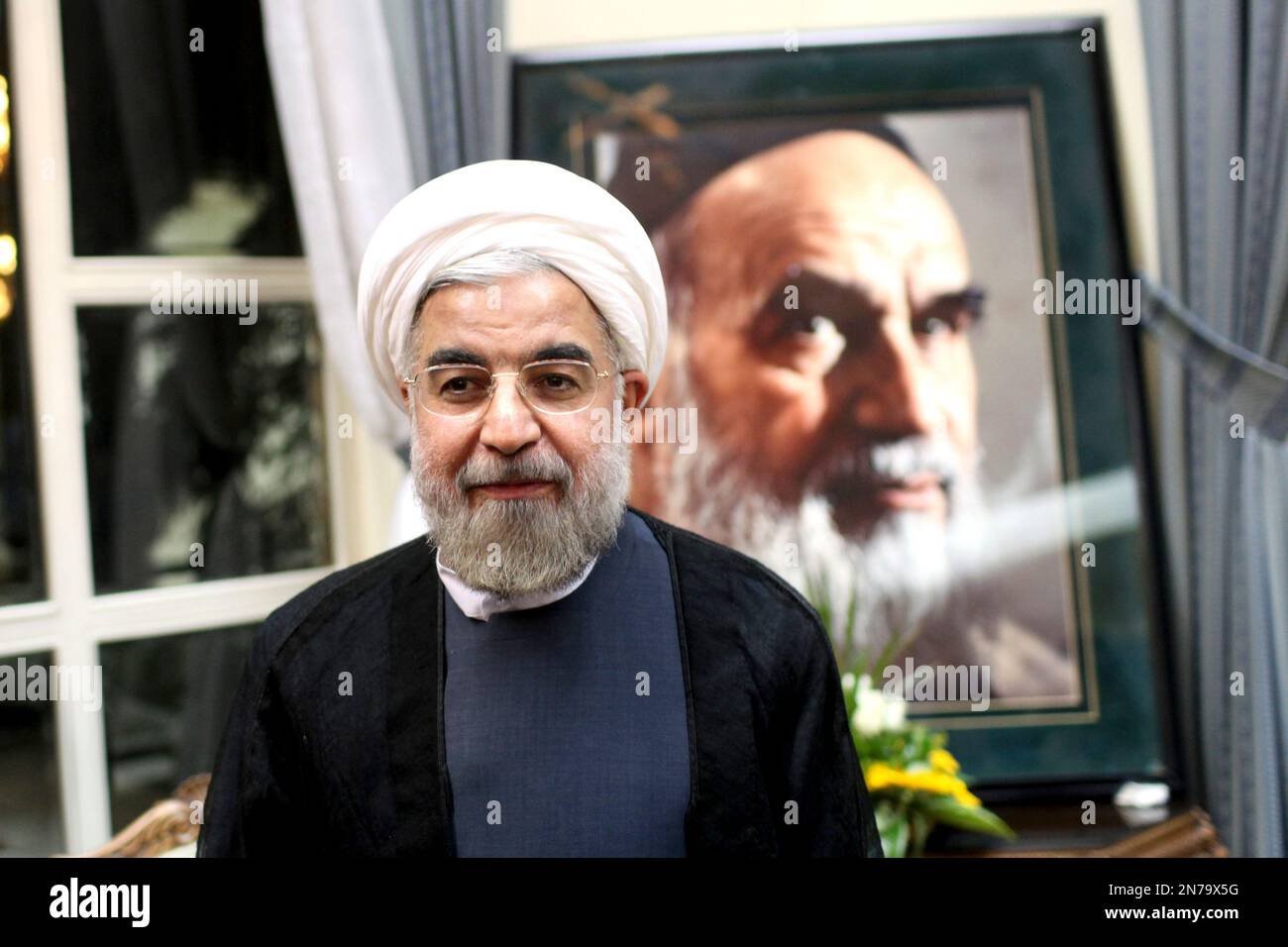 Iranian President elect Hasan Rouhani, stands in front of a portrait of ...