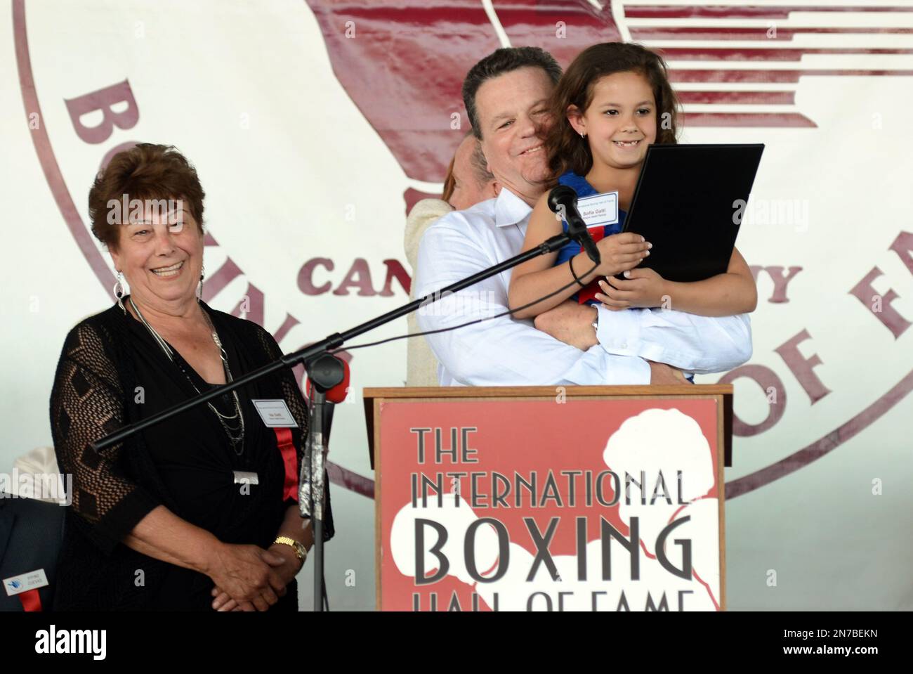 Sofia Gatti, 7, is hoisted up to the podium by Pat Lynch, former ...