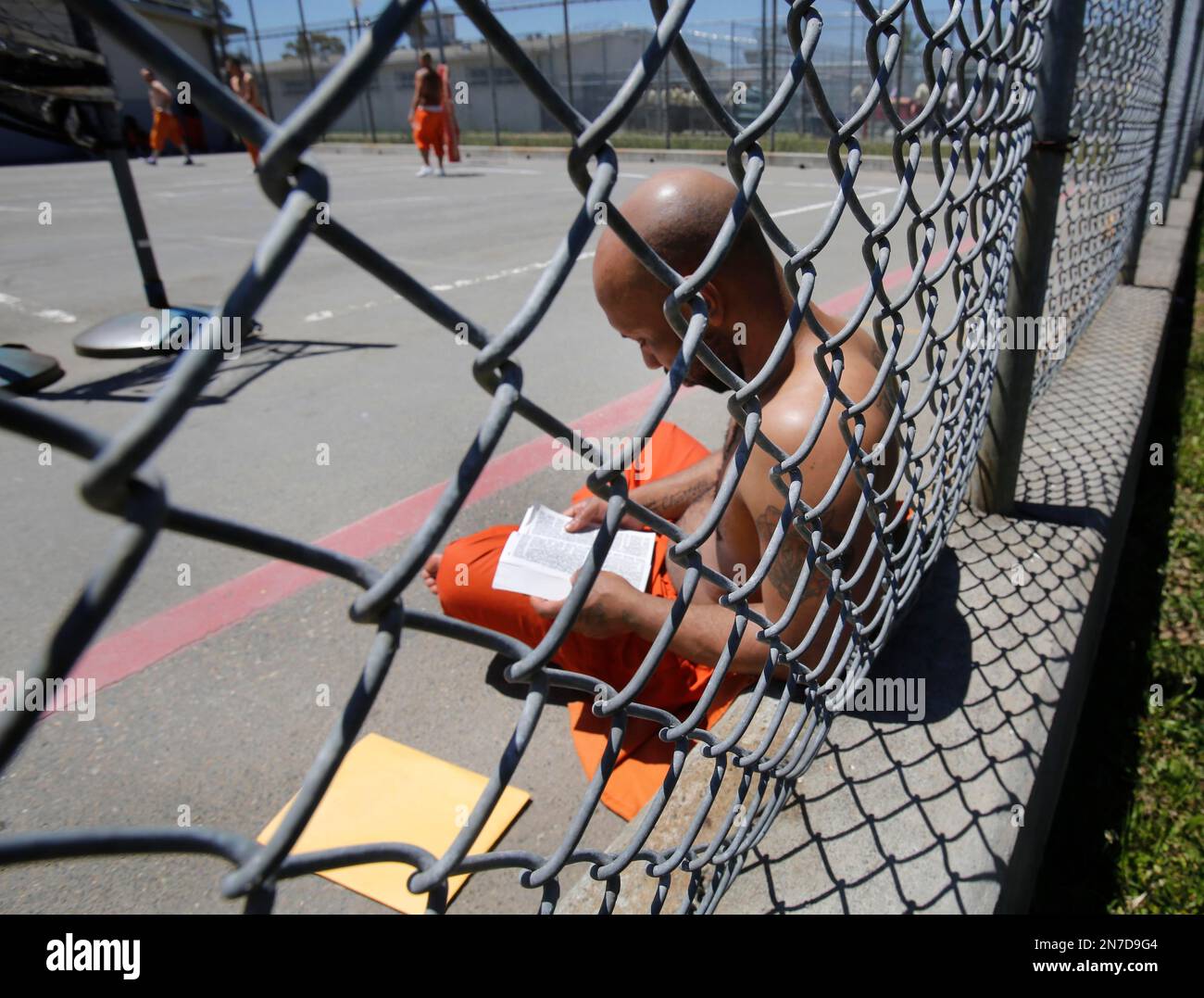 Inmate Curtis Colvard Sr. reads a Bible in the exercise yard of ...