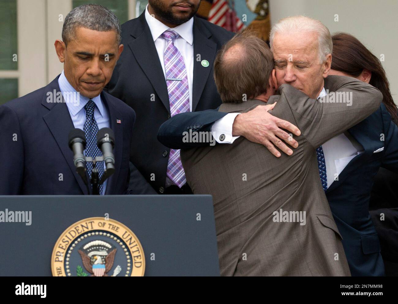 President Barack Obama stands at the podium at left as Mark Barden, the ...