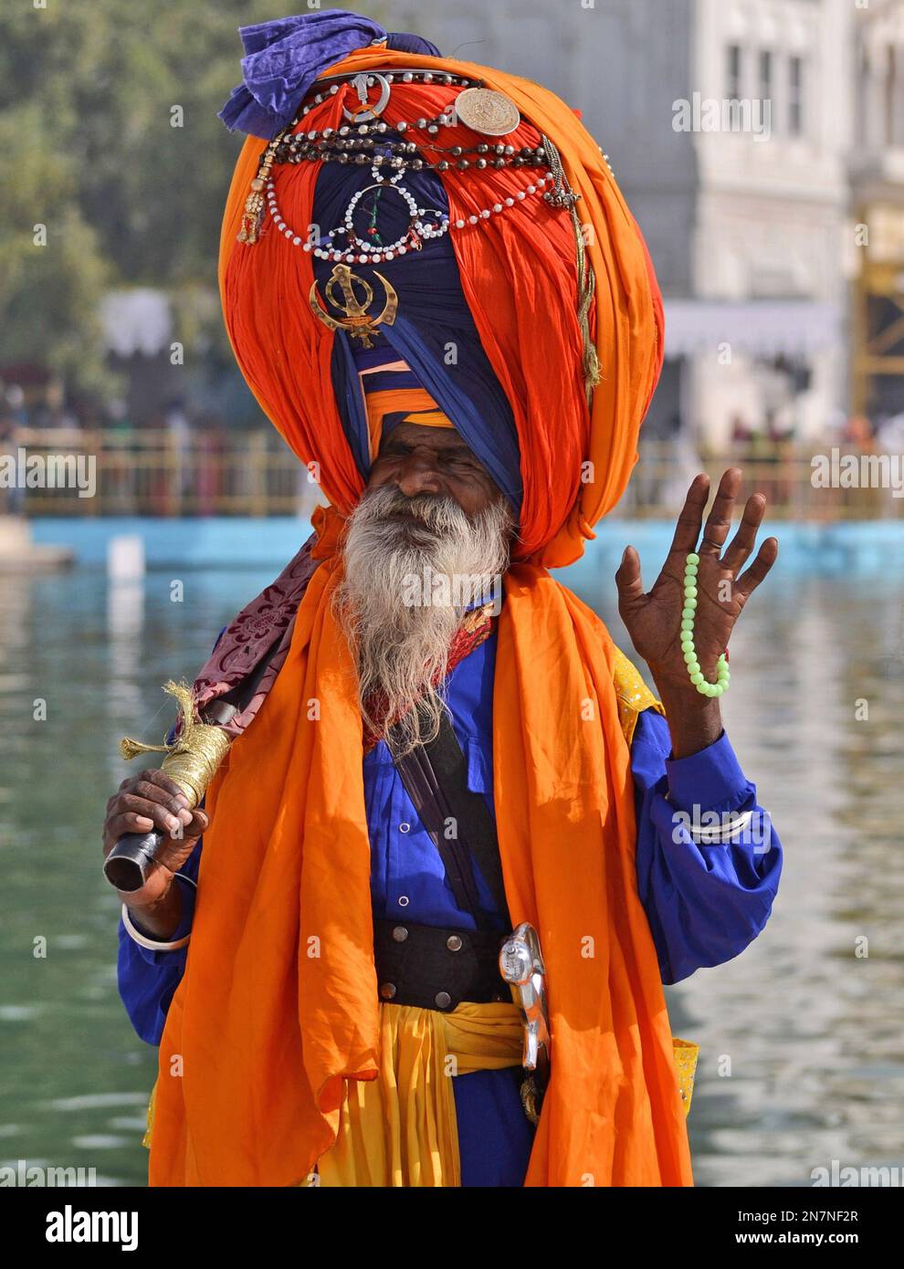 A nihang, or Sikh warrior, wearing a giant headgear poses for ...