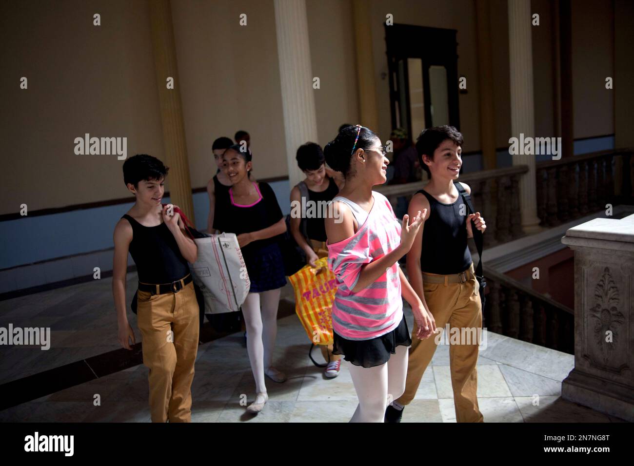 In this April 3, 2013 photo, identical triplets Marcos, Cesar, and ...