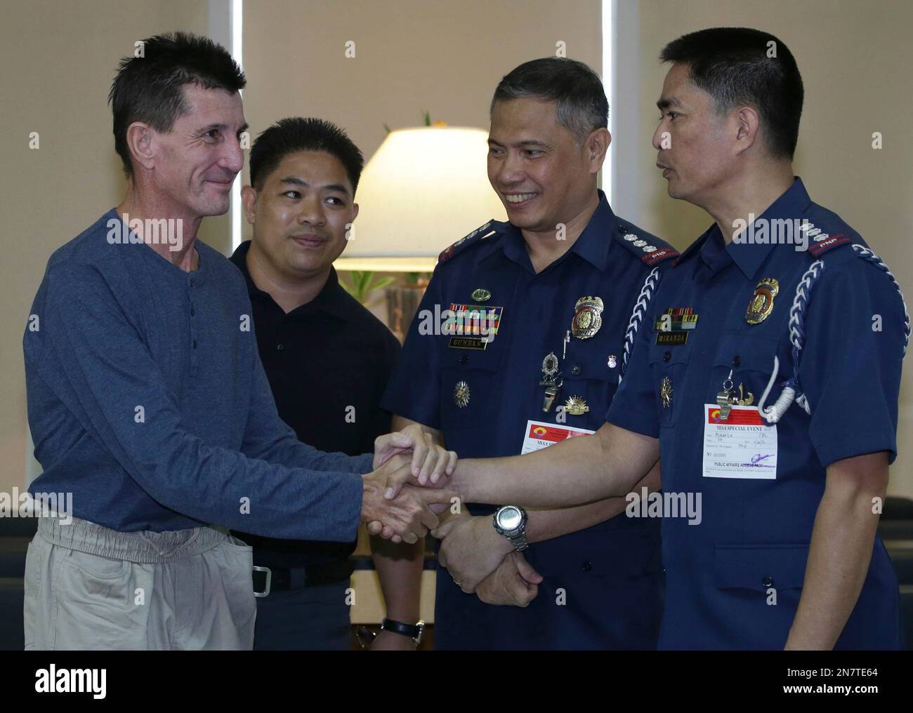 Freed Australian hostage Warren Richard Rodwell, left, greets Col. Rolando Miranda, right ...