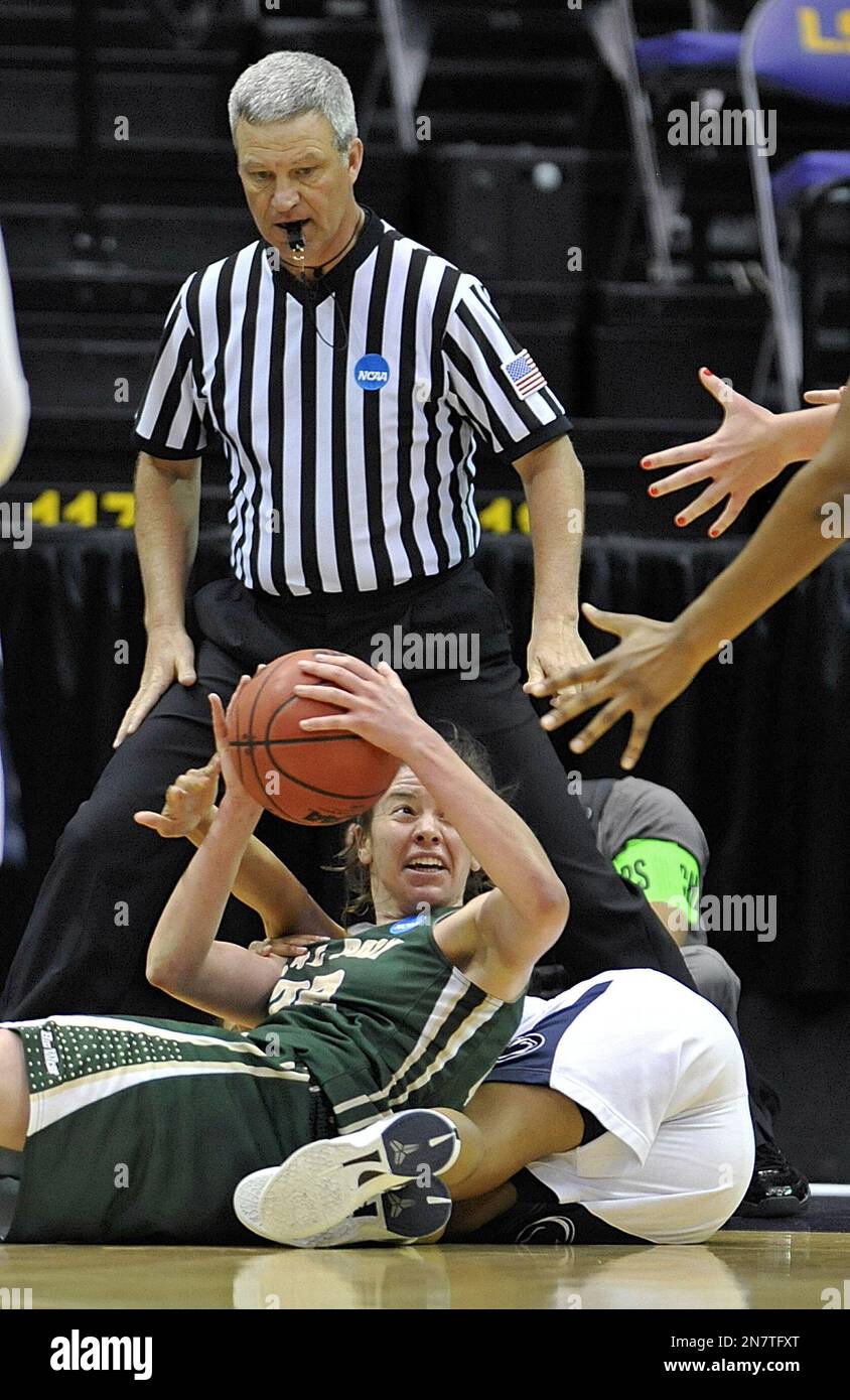 A referee watches as Cal Poly guard Caroline Reeves, left, looks to ...