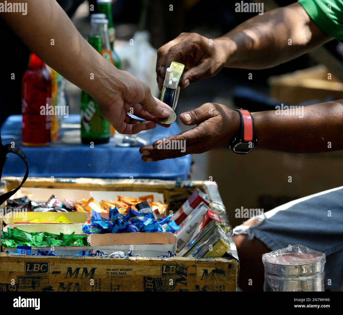 A Filipino job applicant buys cigarettes while waiting for his ...