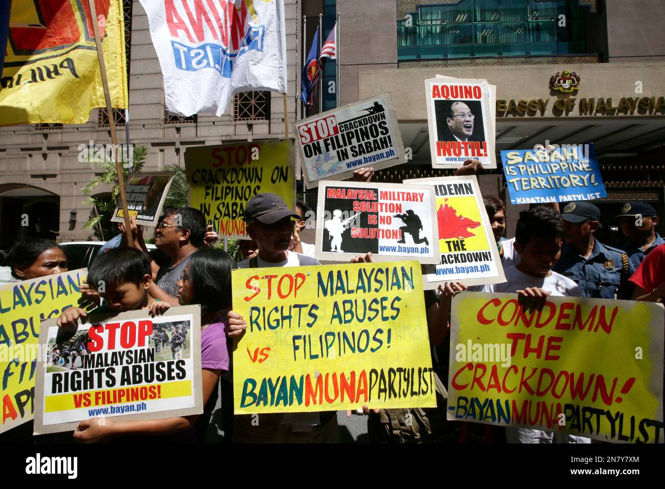 Protesters display placards during a rally outside the Malaysian ...