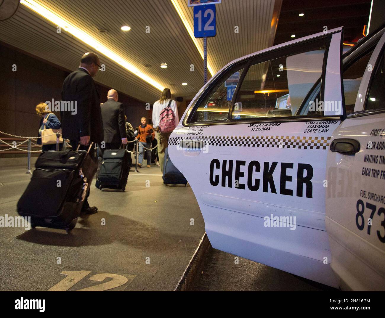 Travelers arriving at McCarran International Airport make their way ...