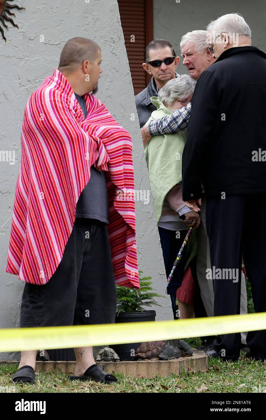 Family members console each other near the home where Jeff Bush ...