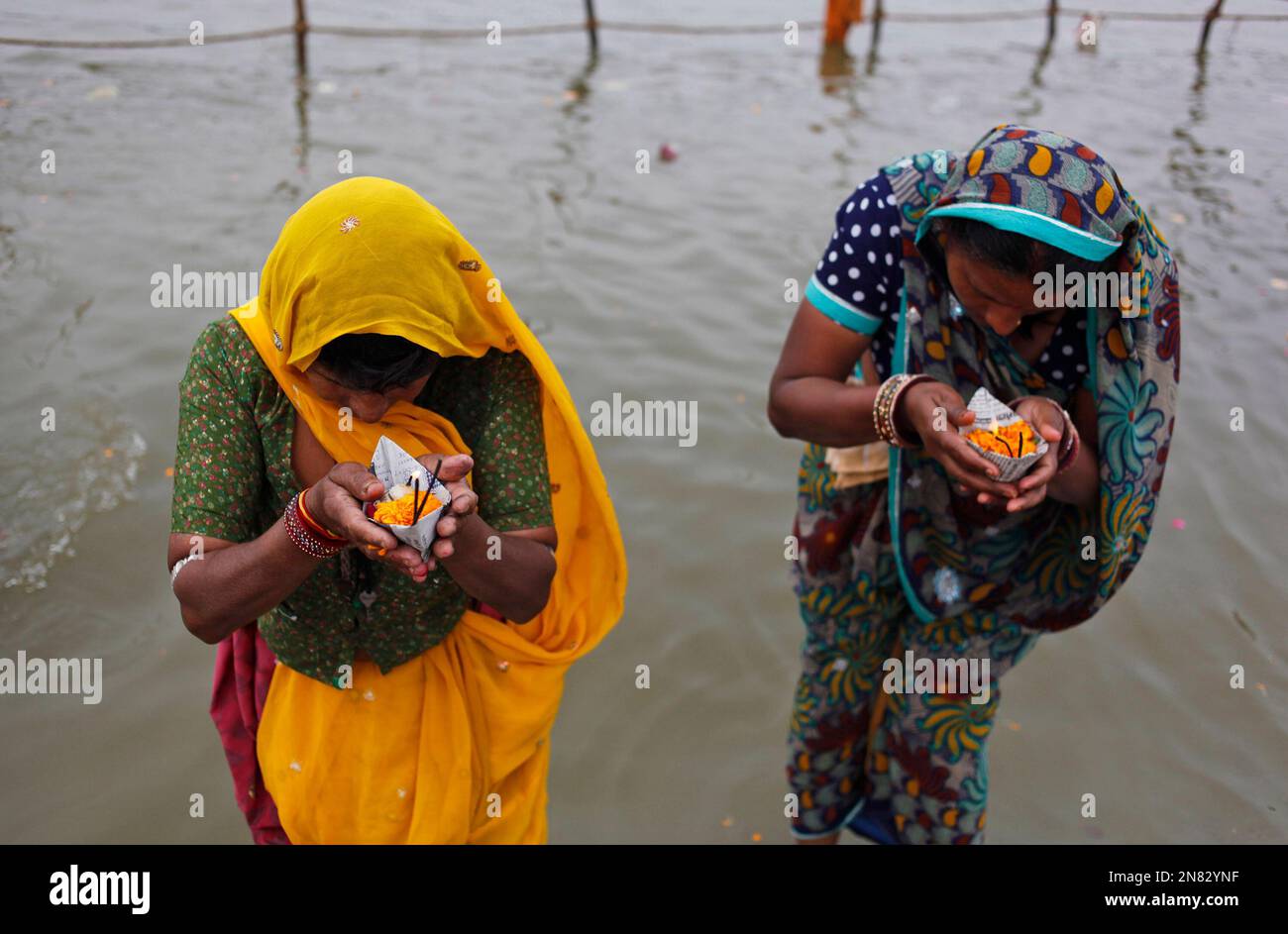 Hindu devotees perform rituals at the Sangam, confluence of Hindu holy ...
