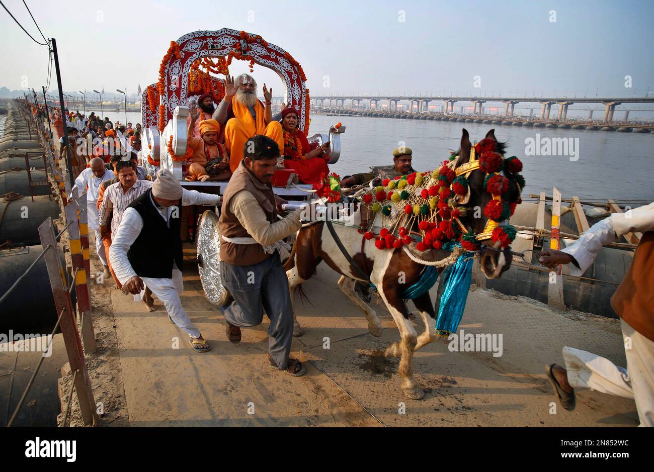 Disciples help a carriage over an incline as a Hindu holy man ...