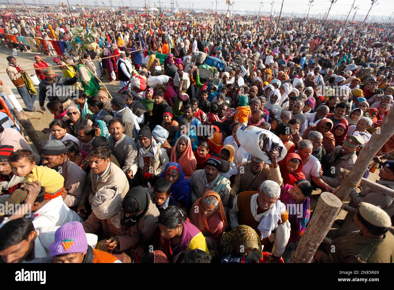 Indian devotees arrive for a holy dip at Sangam, the confluence of the ...