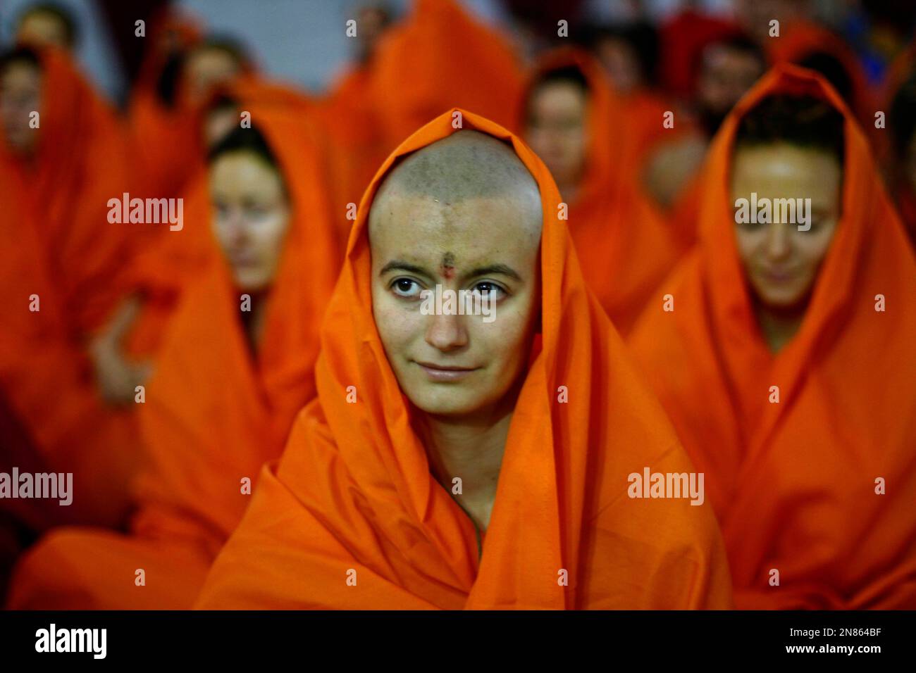 Female foreign devotees participate in a consecration ceremony for ...