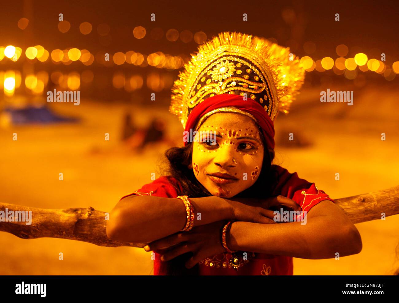 An Indian child dressed as Hindu goddess Parvaty watches a religious ...
