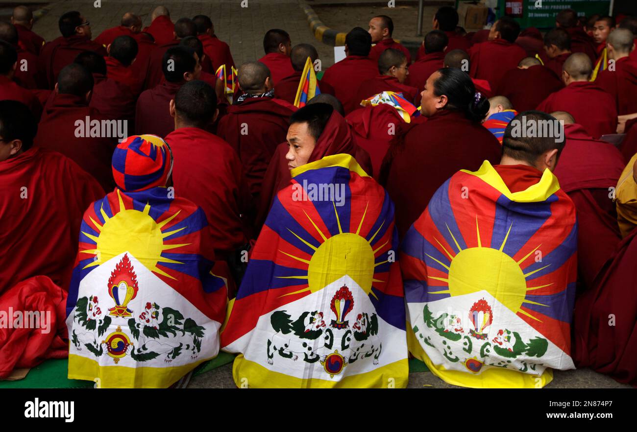 Exiled Tibetan Buddhist monks and nuns with a Tibetan flag wrapped ...