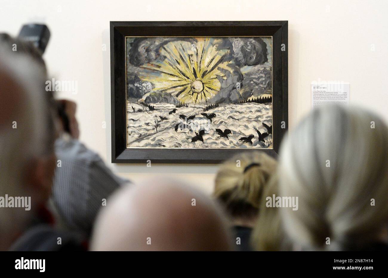 Visitors stand in front of the painting 'Sunrise' (1913, Oil on canvas ...