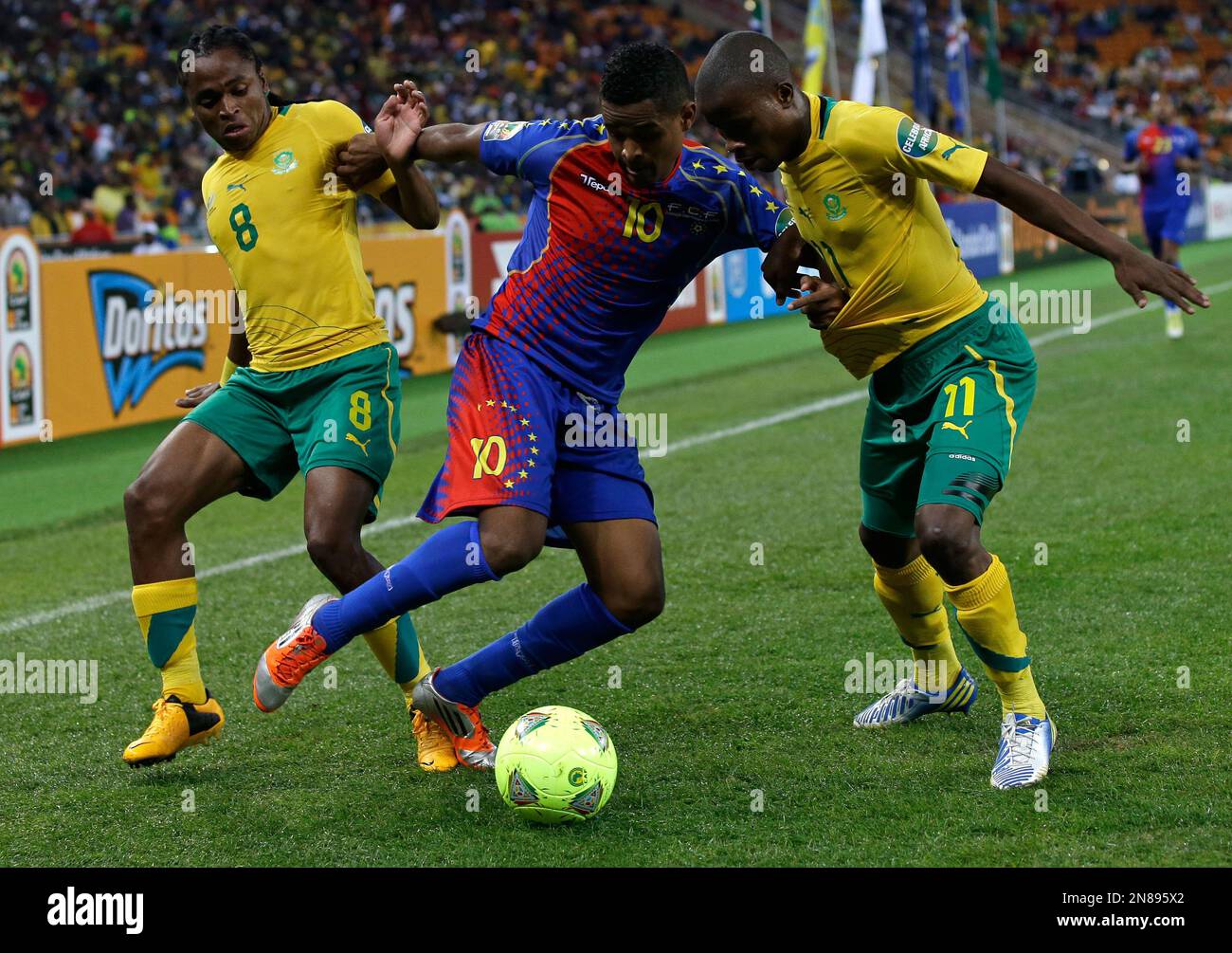 Cape Verde's Heldon Ramos, center, struggles to get past South Africa's ...