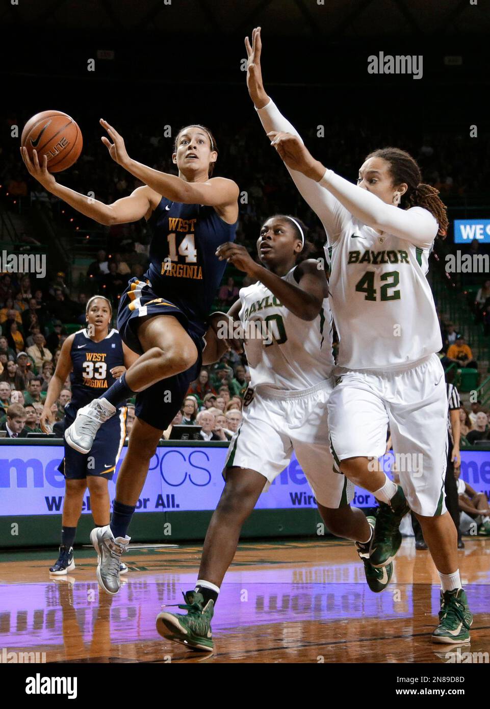West Virginia forward Jess Harlee (14) goes up for a shot as Baylor's ...