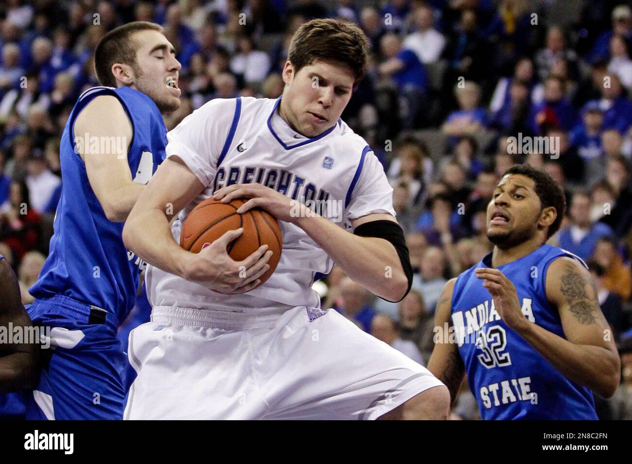 Creighton's Doug McDermott, center, grabs a rebound against Indiana ...