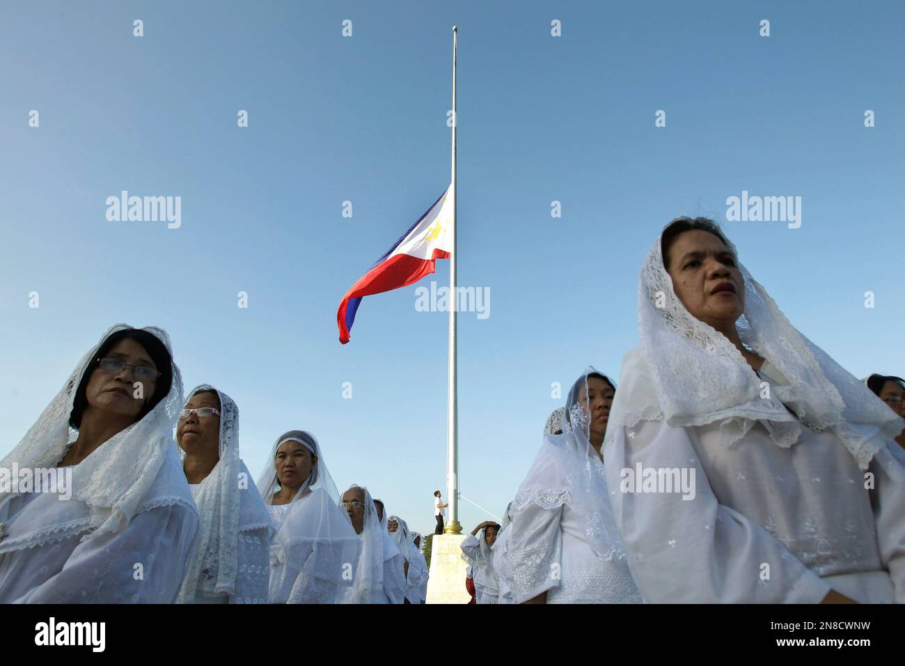 Followers of Philippine national hero Jose Rizal stand in front of the ...