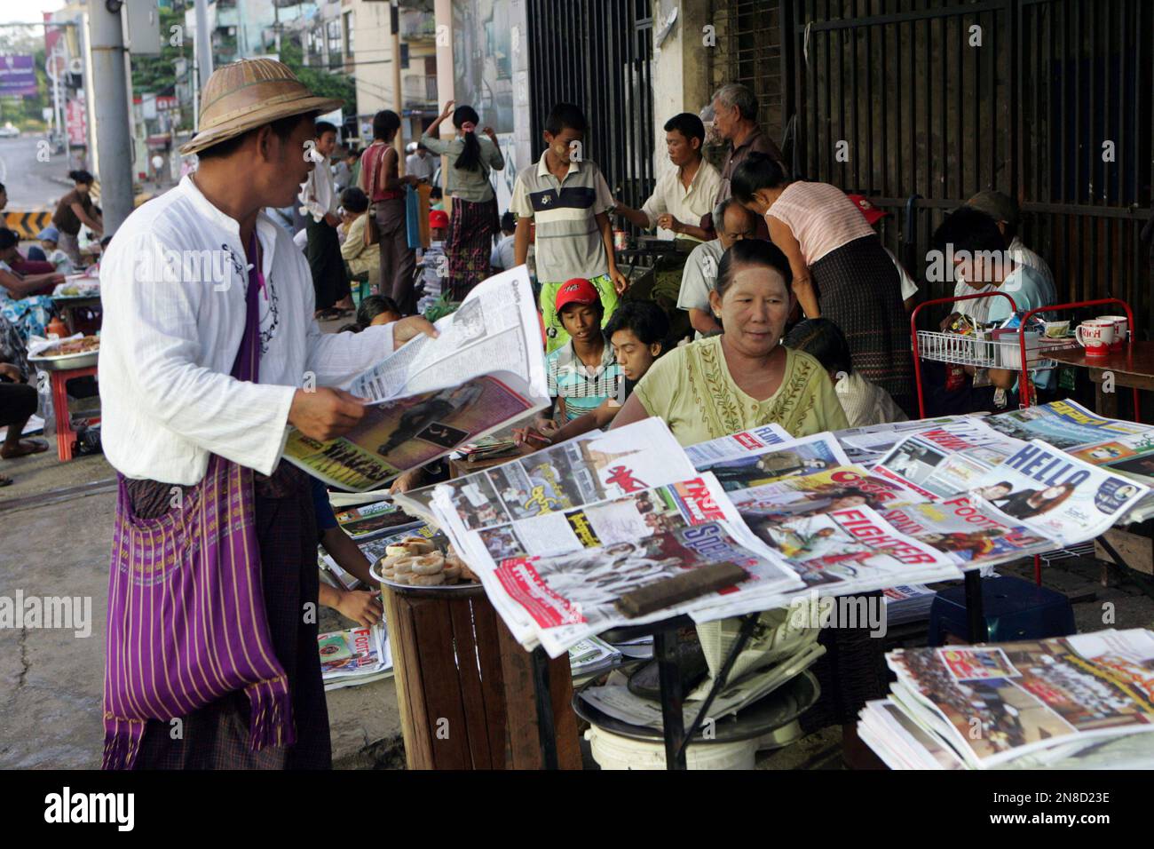 FILE - In this June 10, 2012 file photo, a man buys a weekly news ...