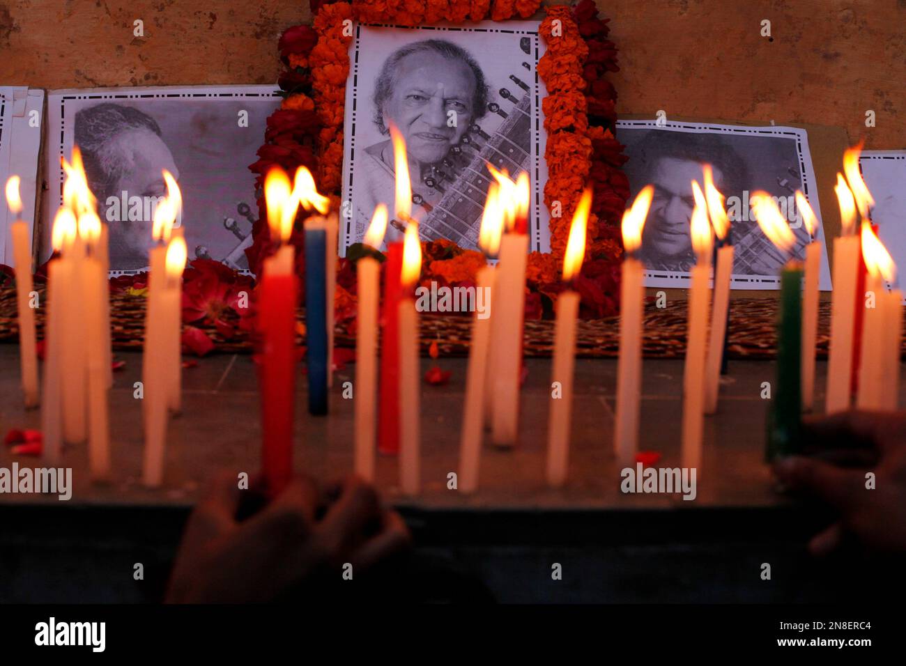 Students and teachers light candles to pay tribute to legendary Indian ...