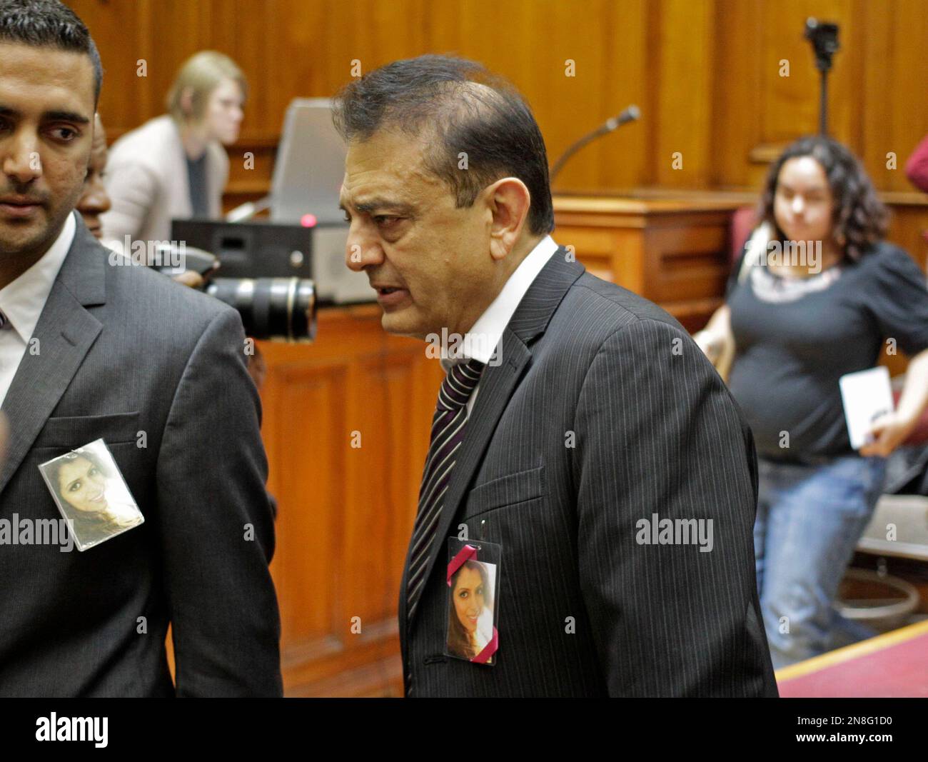 Vinod Hindocha, center, arrives in court with a photo of his slain ...