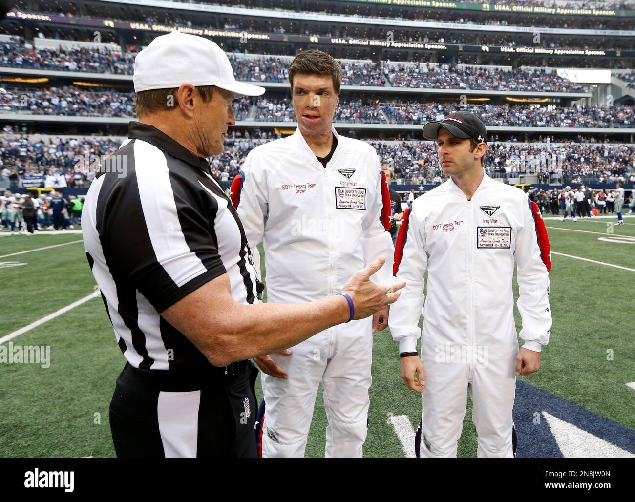 Referee Ed Hochuli (85) talks with members of the Sons of Flag Burn ...