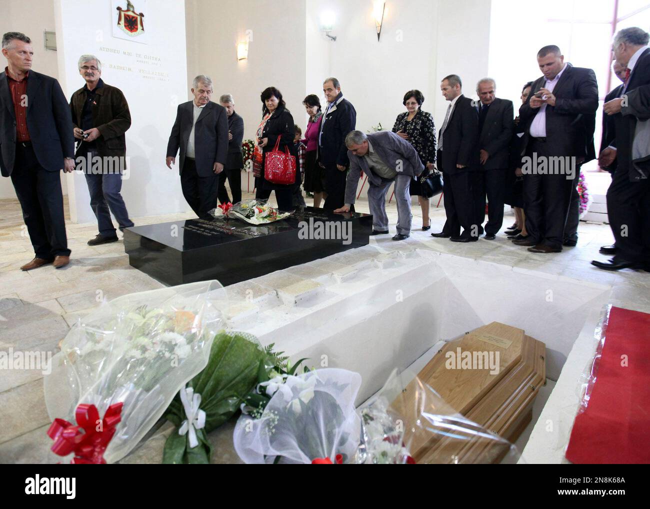People pay their last respect by the coffin of Albania's only post ...