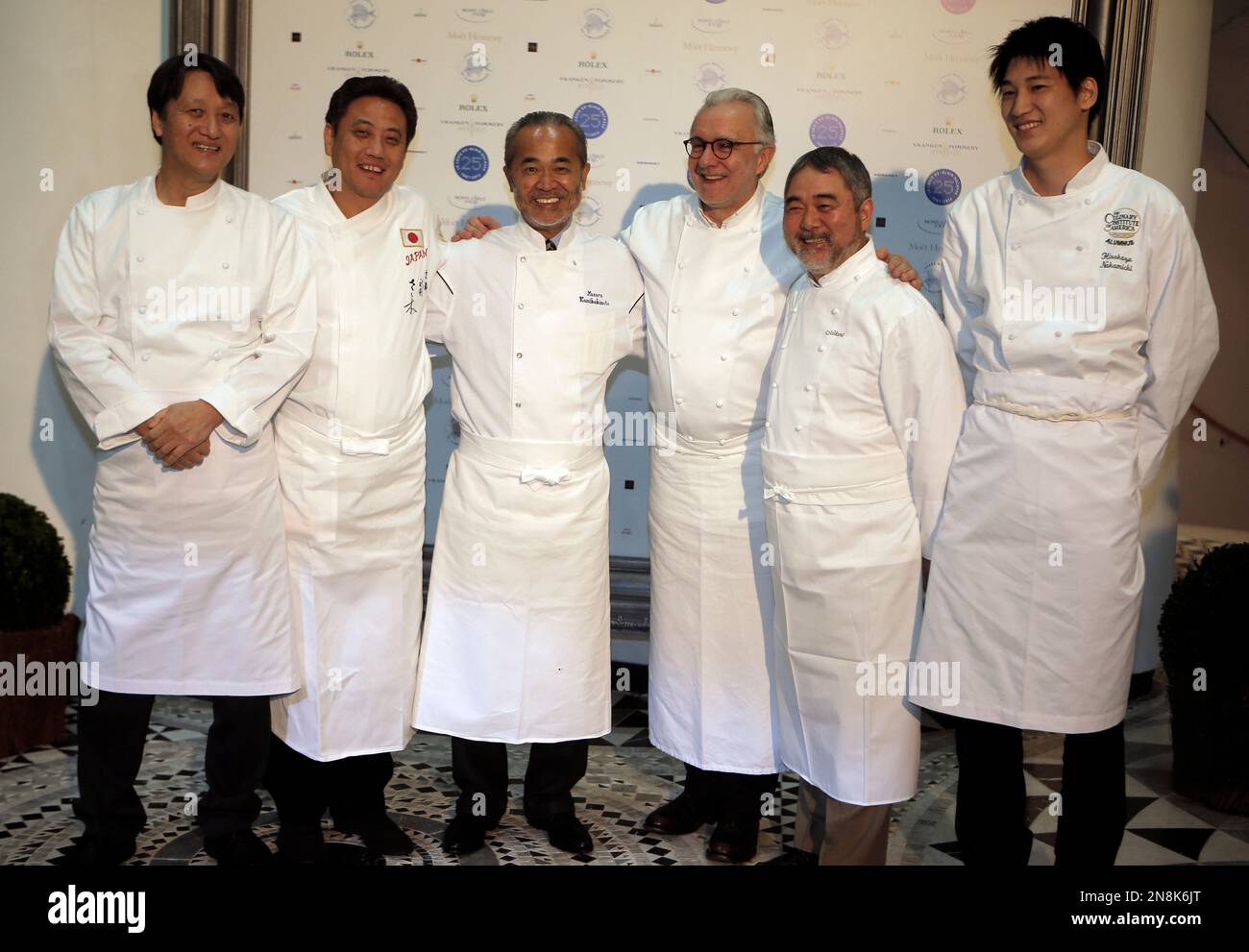 French chef Alain Ducasse, center, poses with left to right, Hiroyuki Kanda, Hiroshi Sasaki ...