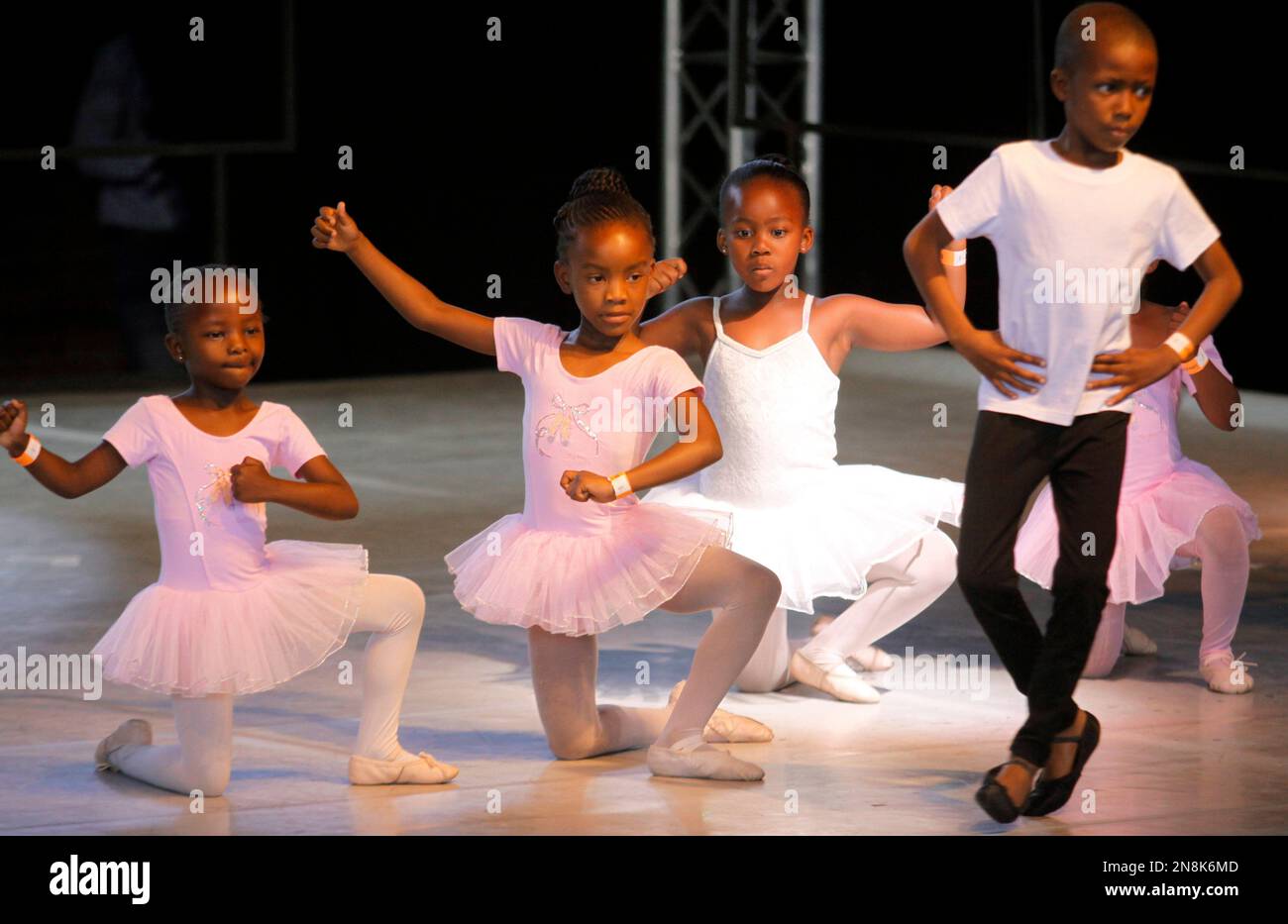Young ballerinas perform a dance on stage in Alexandra Township north of Johannesburg, Saturday ...