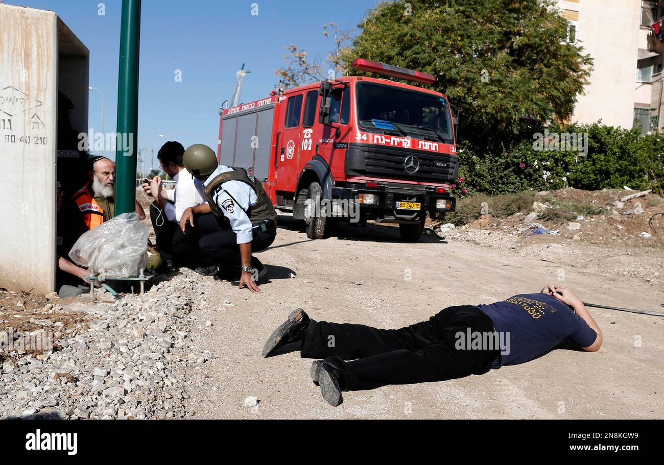 Israelis Take Cover As A Siren Warning Of An Incoming Rocket Sounds In