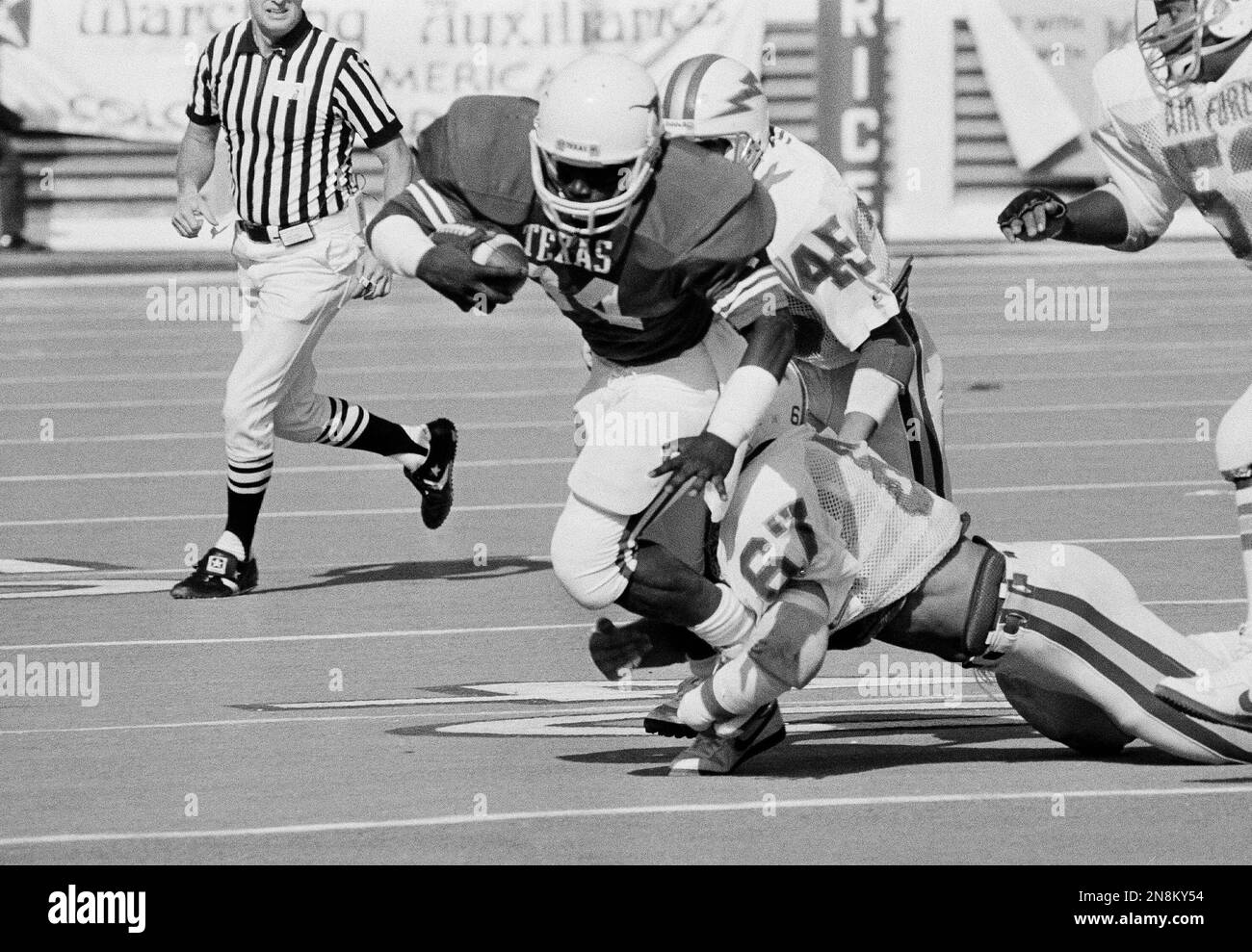 University of Texas' Darron Norris (34) around his right end picks four ...