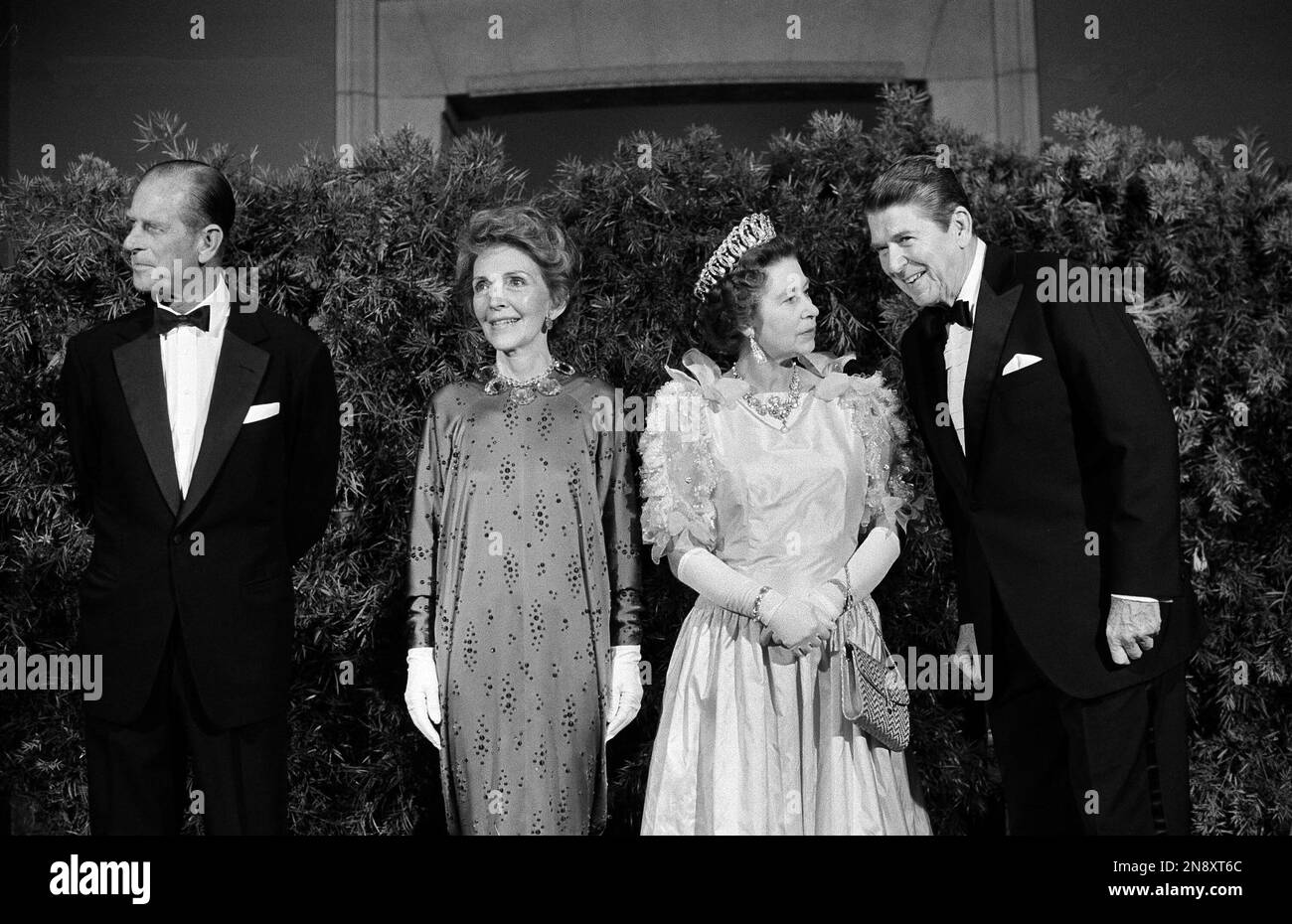 President Ronald Reagan listens as he poses for photographers with ...